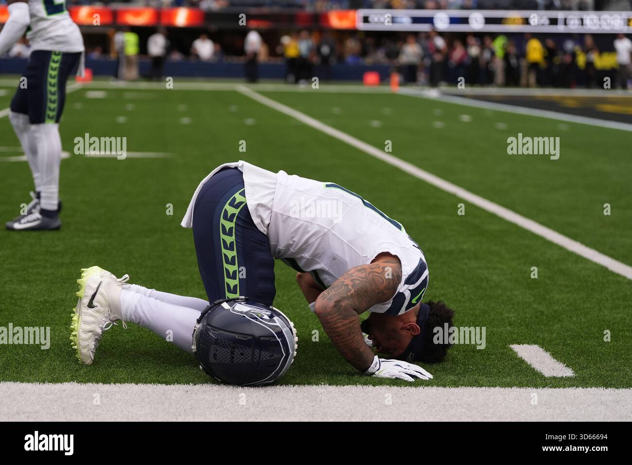 Seattle Seahawks wide receiver Jaxon Smith-Njigba takes a moment to pray before an NFL football ...