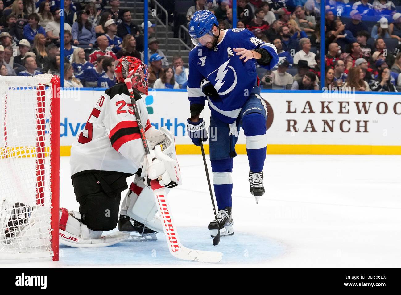 Tampa Bay Lightning right wing Nikita Kucherov (86) talks to New Jersey Devils goaltender Jacob ...