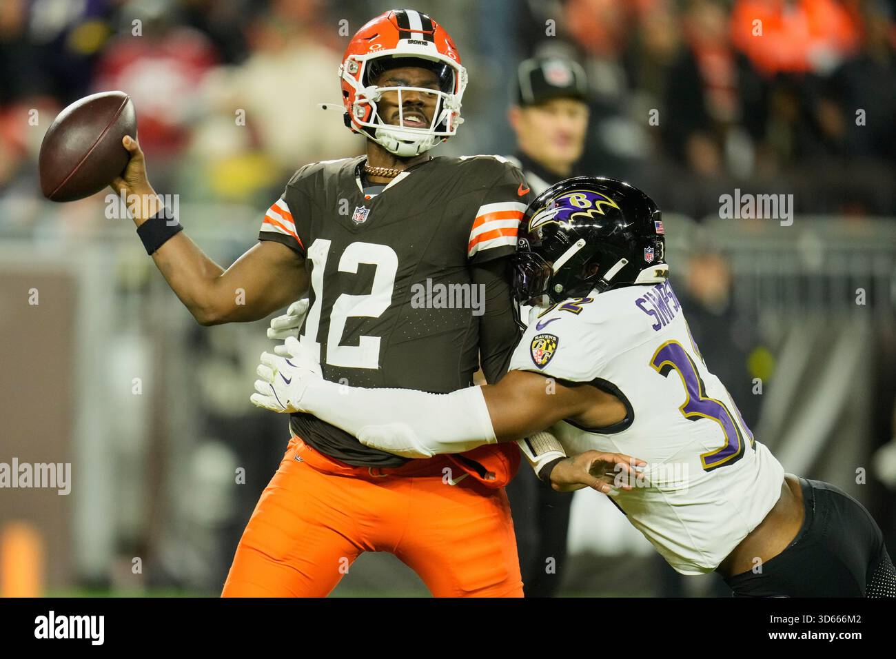 Cleveland Browns quarterback Shedeur Sanders (12) passes as he is hit ...