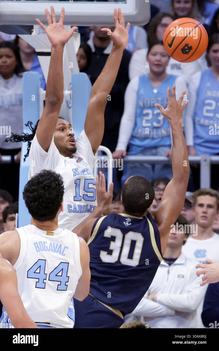 Navy forward Mike Woods (30) attempts a shot as he is defended by North ...
