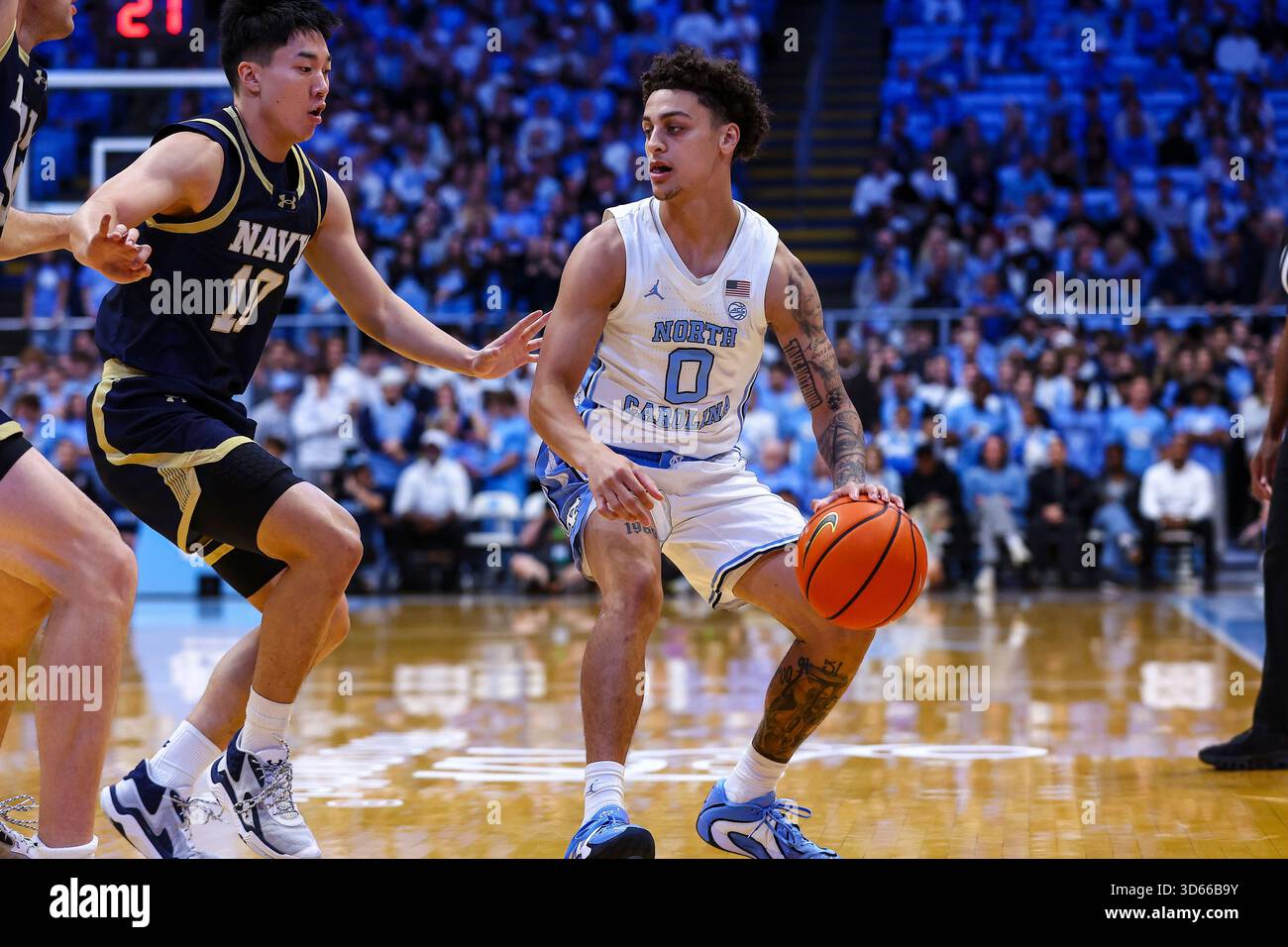 November 18, 2025: North Carolina guard Kyan Evans (0) dribbles the ...