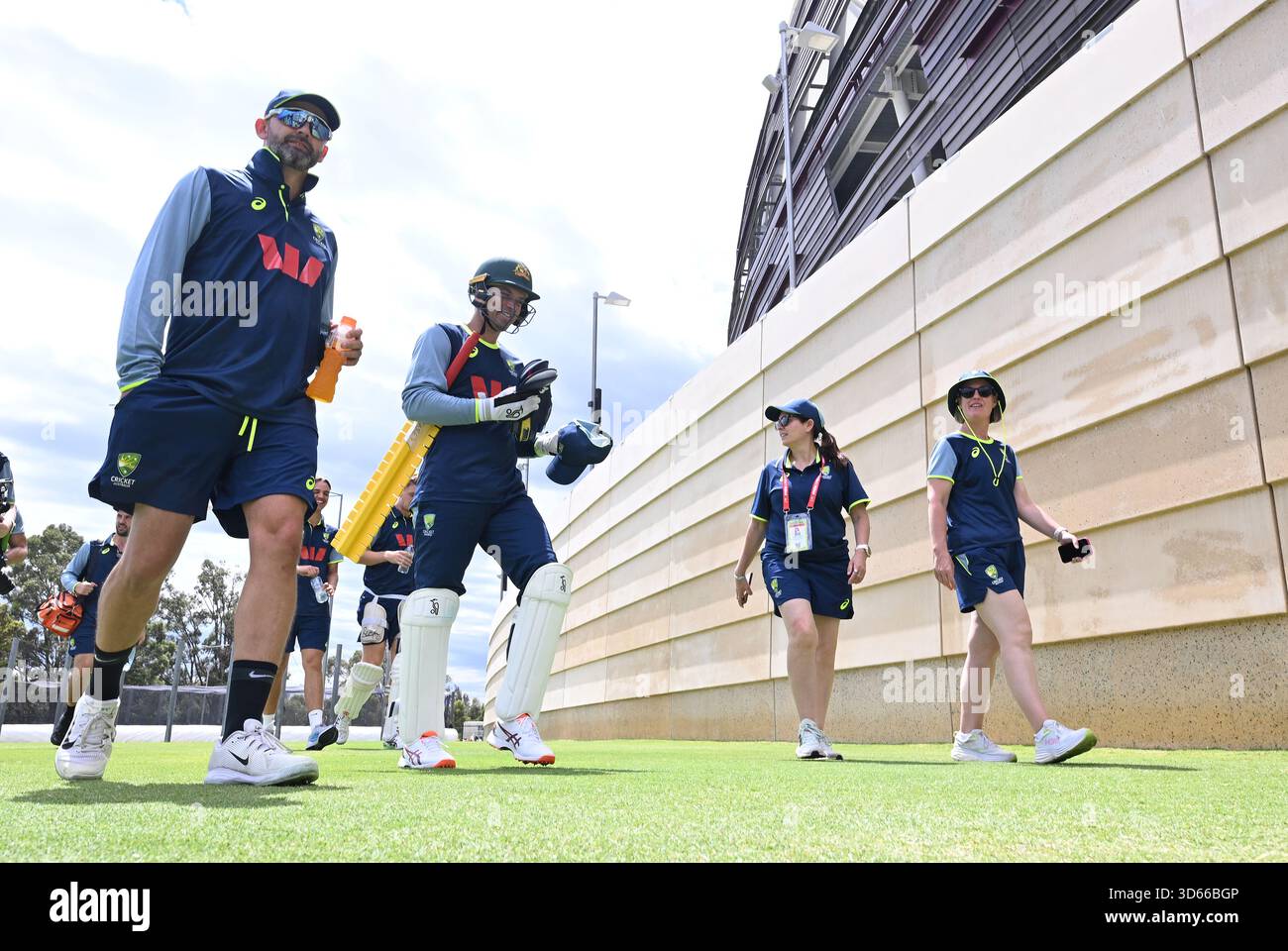Australian cricketers Nathan Lyon (left) and Alex Carey evacuate from a ...