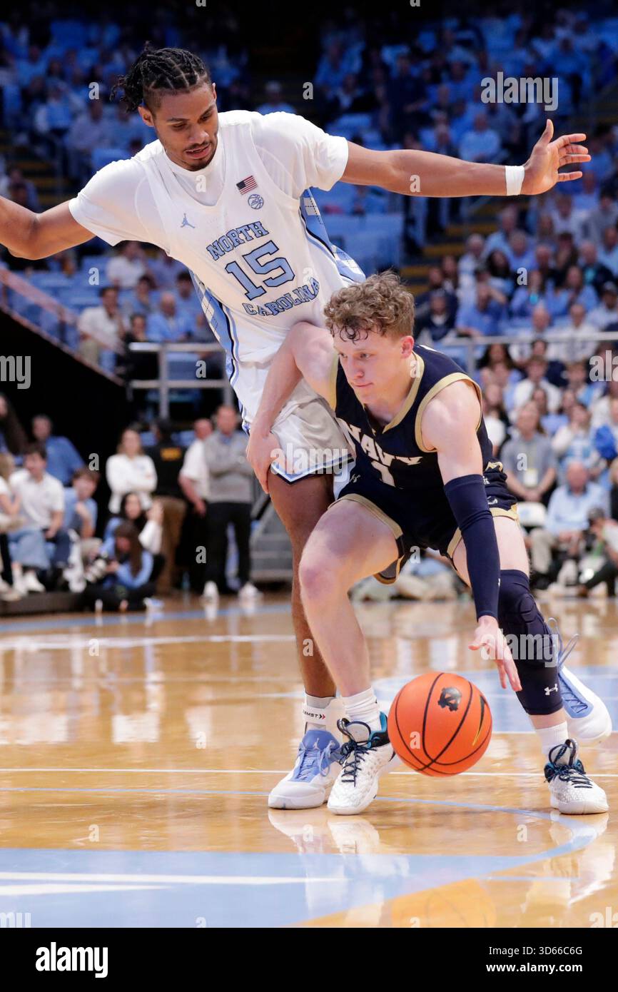 Navy guard Austin Benigni (1) tries to maneuver around North Carolina ...