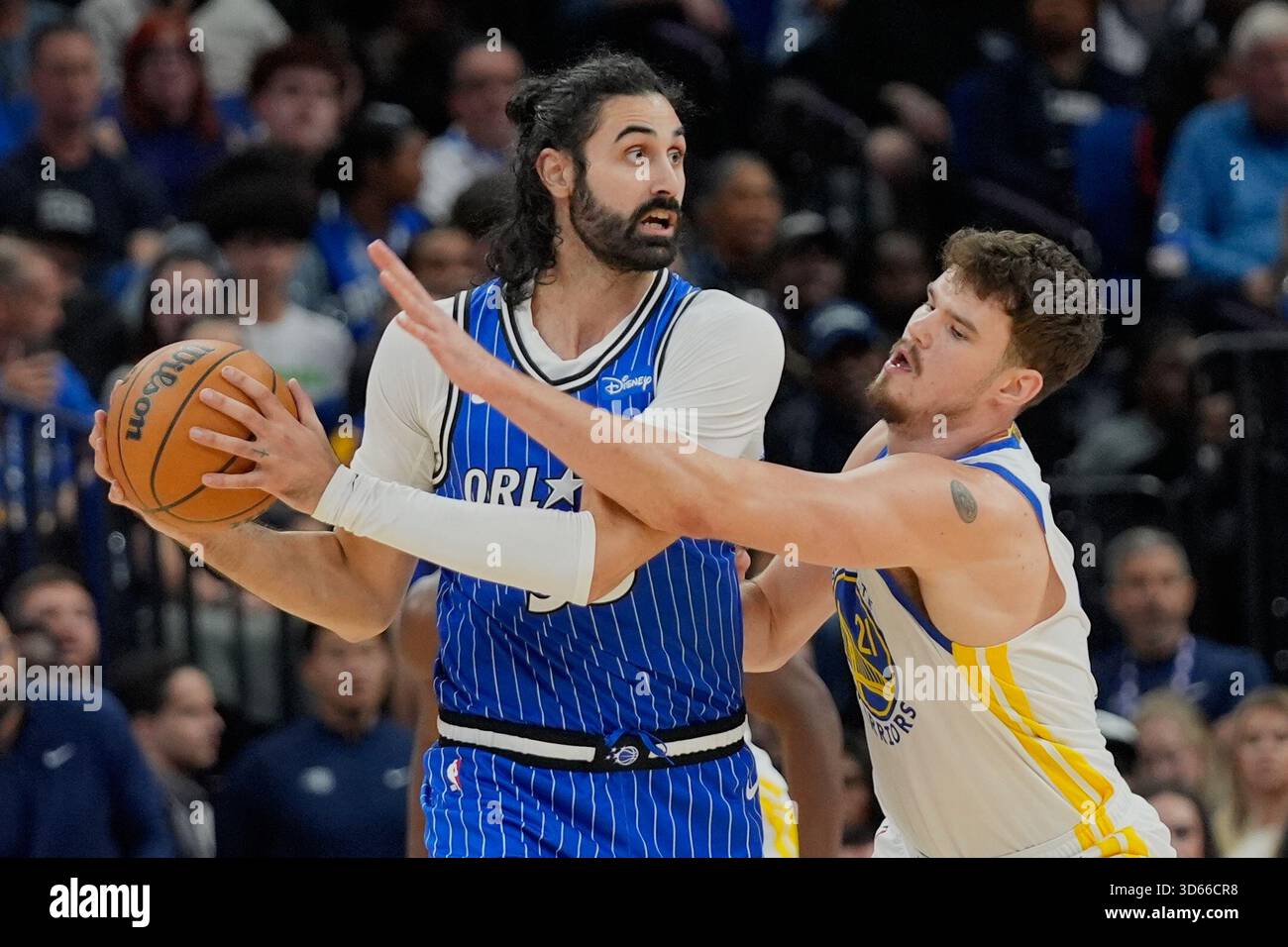 Orlando Magic center Goga Bitadze, left, looks to pass the ball as he ...