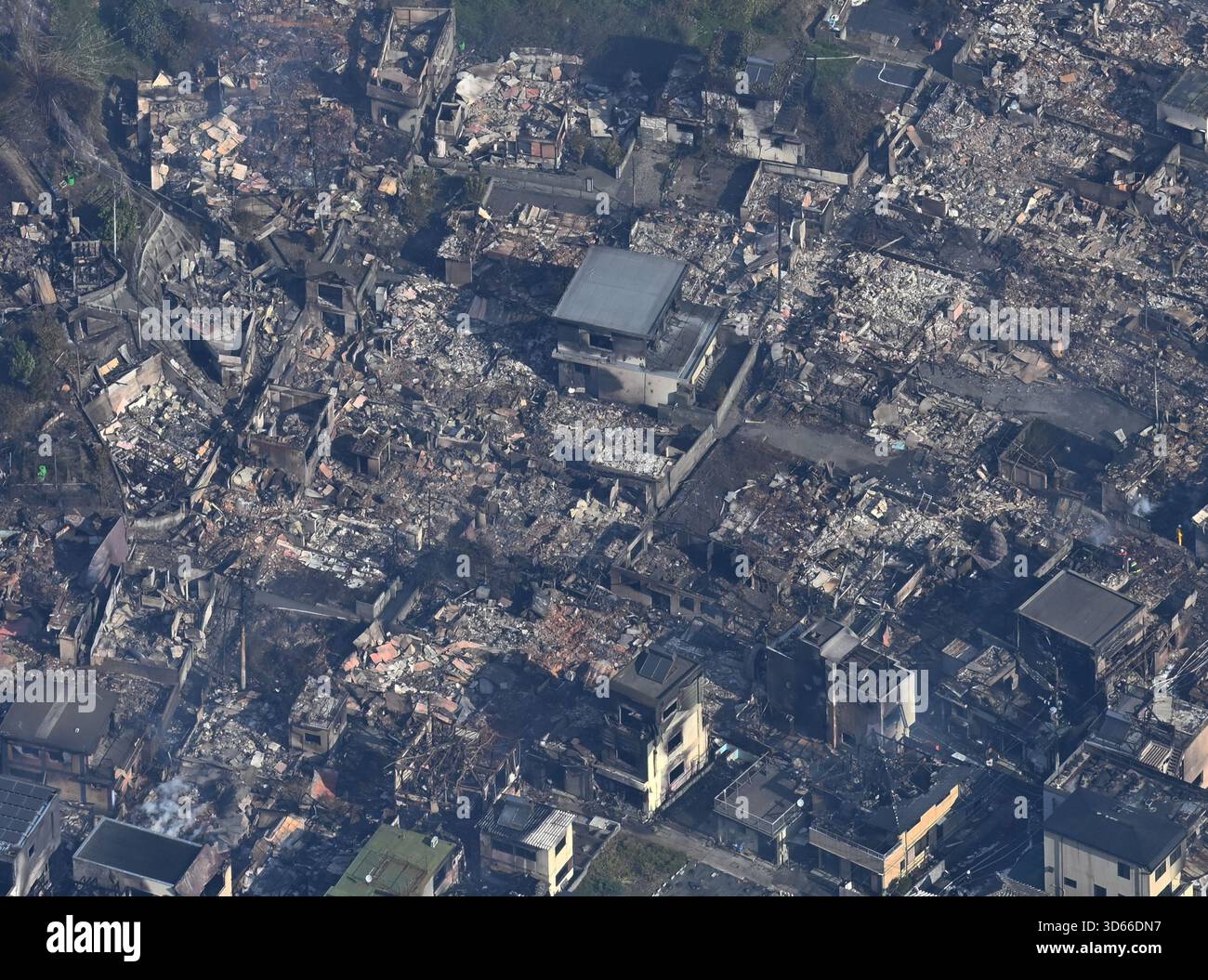 An aerial photograph shows the scene of a large-scale fire in Oita City, Japan, on November 19 ...