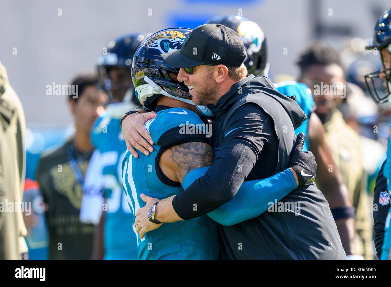 Jacksonville Jaguars head coach Liam Coen smiles as he hugs wide ...