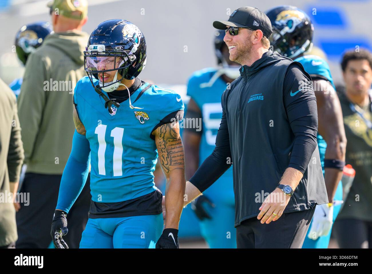 Jacksonville Jaguars head coach Liam Coen talks to wide receiver Parker ...