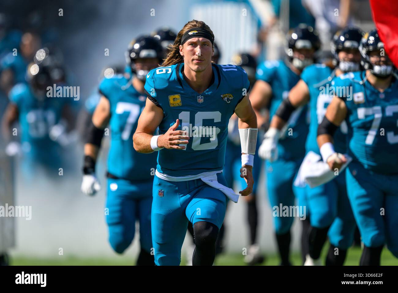 Jacksonville Jaguars quarterback Trevor Lawrence (16) runs onto the ...