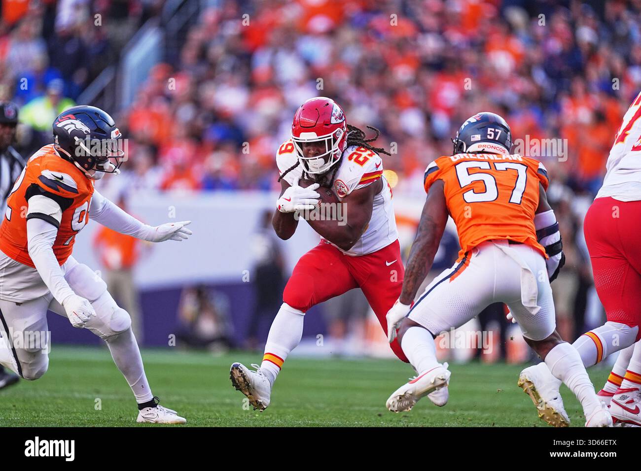 Kansas City Chiefs running back Kareem Hunt (29) runs between Denver Broncos linebackers Dondrea ...