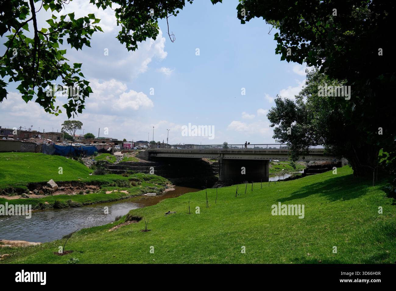 A view of a park along the Jukskei River in the Alexandra township in ...