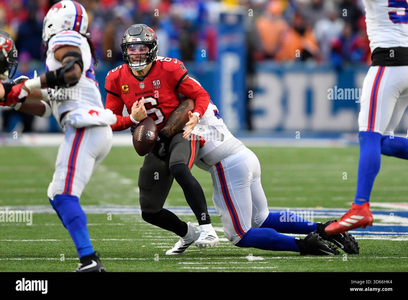 Tampa Bay Buccaneers quarterback Baker Mayfield, left, fumbles as he is sacked by Buffalo Bills ...