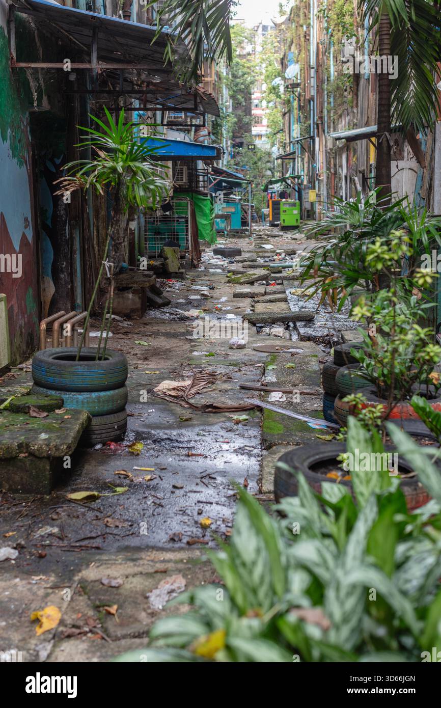Back alleys with dumped rubbish between old streets in Downtown, Yangon ...