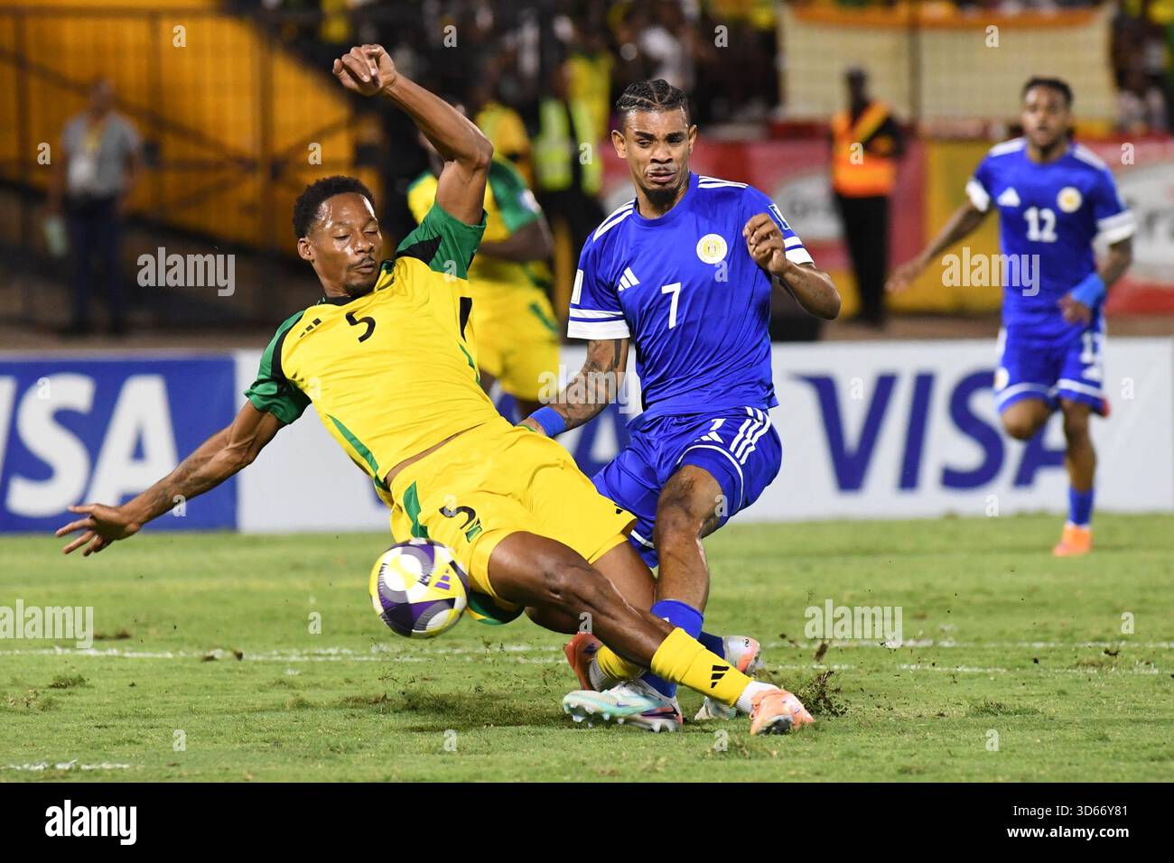 Curaçao's Juninho Bacuna, center, fight for the ball against Jamaica's ...