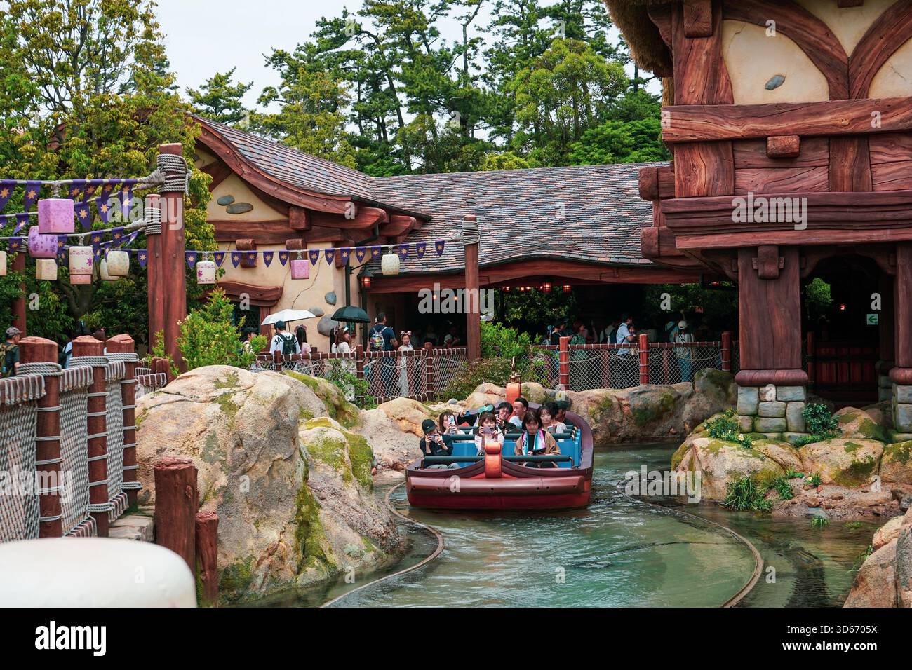 Tourists ride Rapunzel's Lantern Festival boat ride in Tokyo DisneySea ...