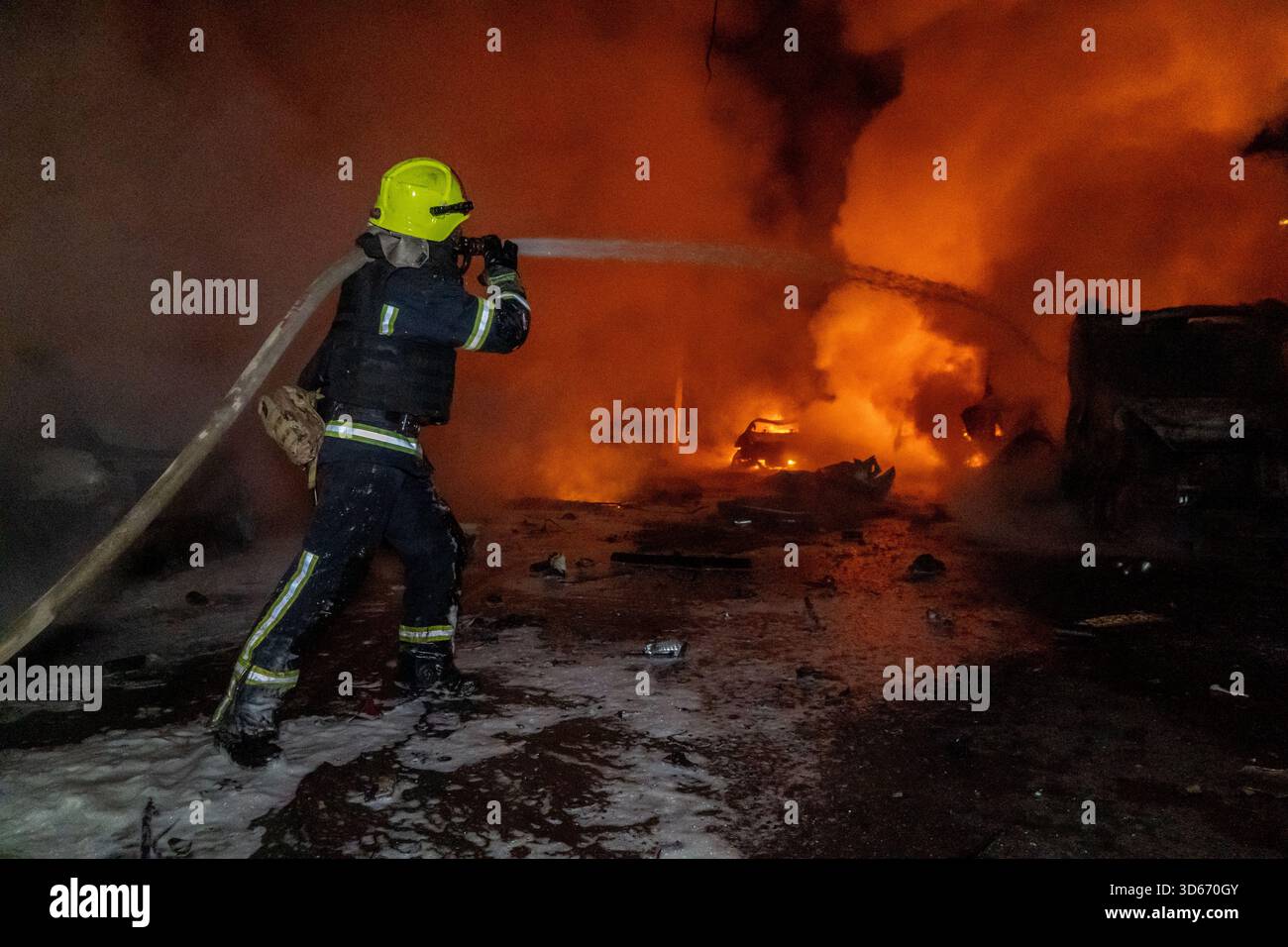 Rescue workers put out a fire of a residential building damaged by a ...
