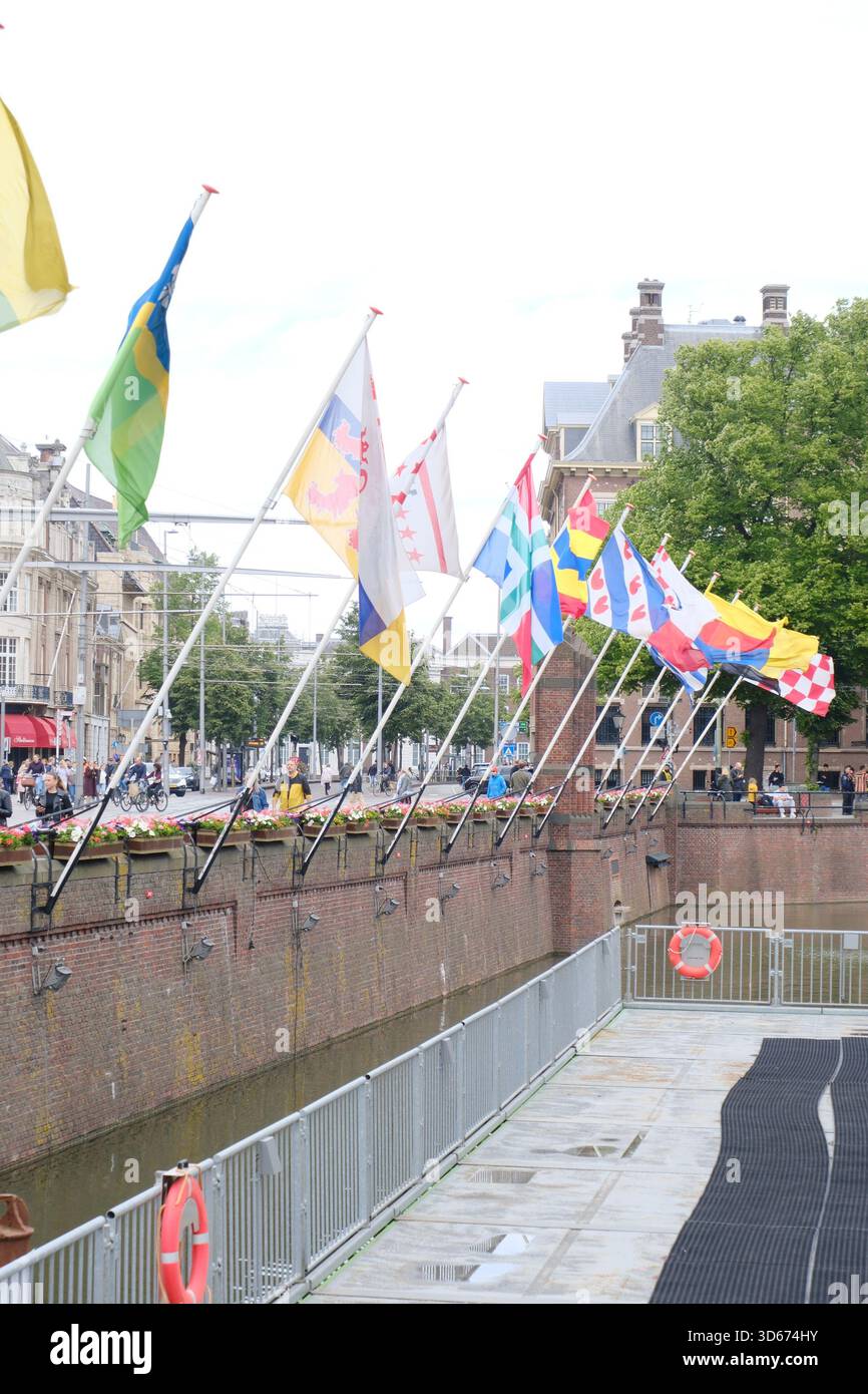 Flags of all dutch provinces lining the court pond (hofvijver) in front ...