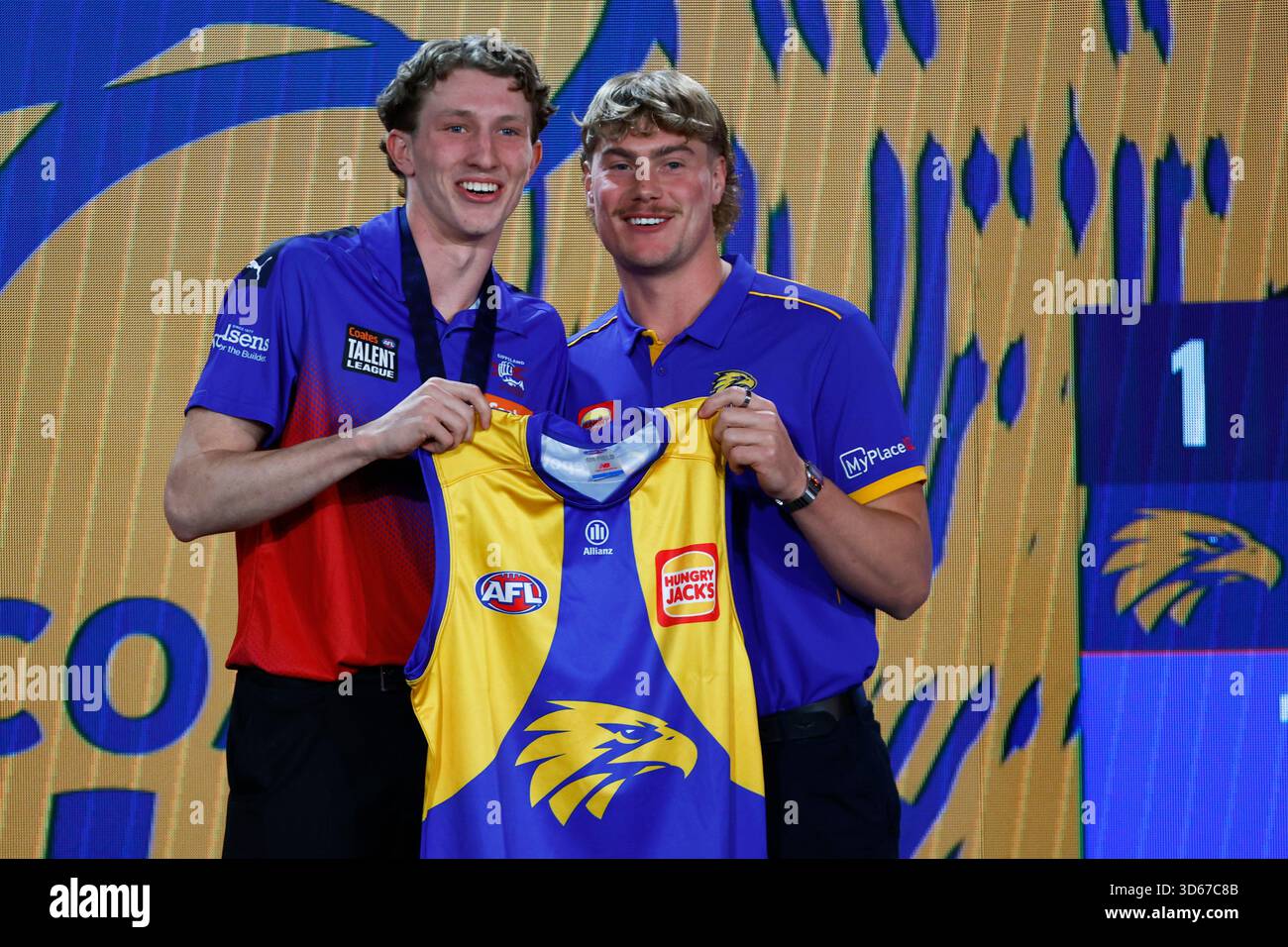 Number One pick Willem Duursma is presented his jumper by Harley Reid ...