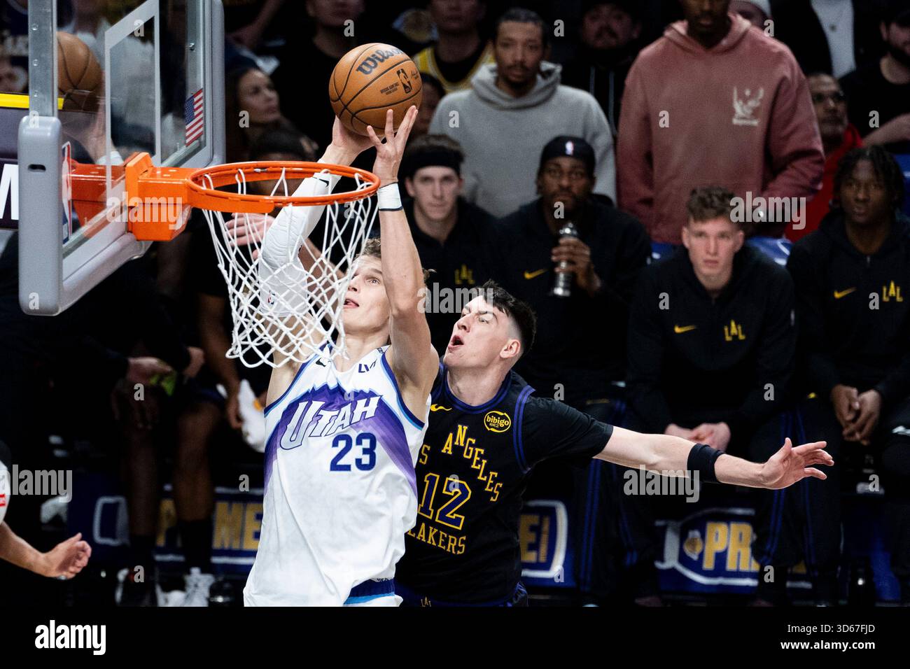 Utah Jazz's Lauri Markkanen (23) goes to the basket under pressure from Los Angeles Lakers’ Jake ...