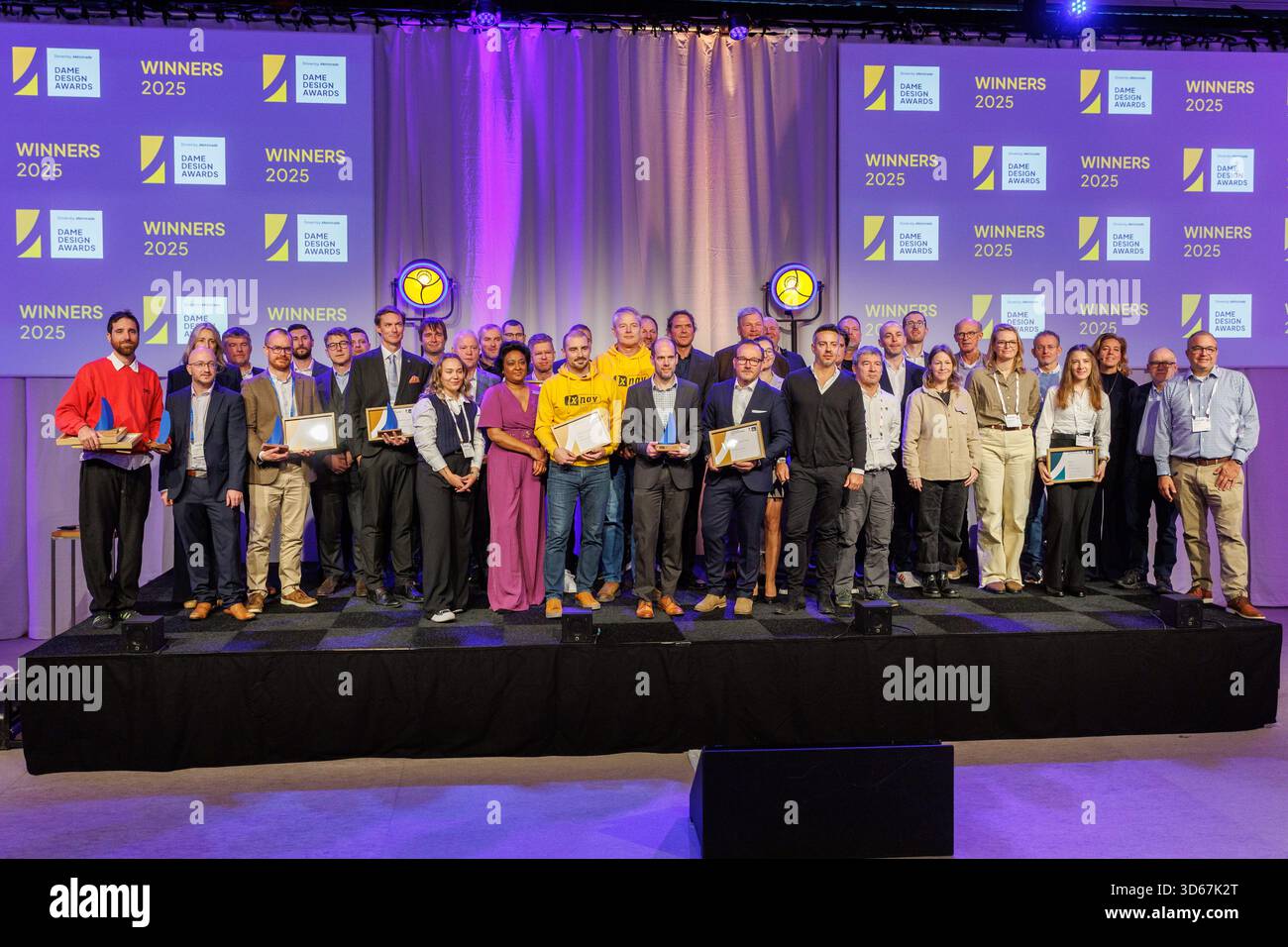 Winners and participants pose for a group photo during the DAME Design ...