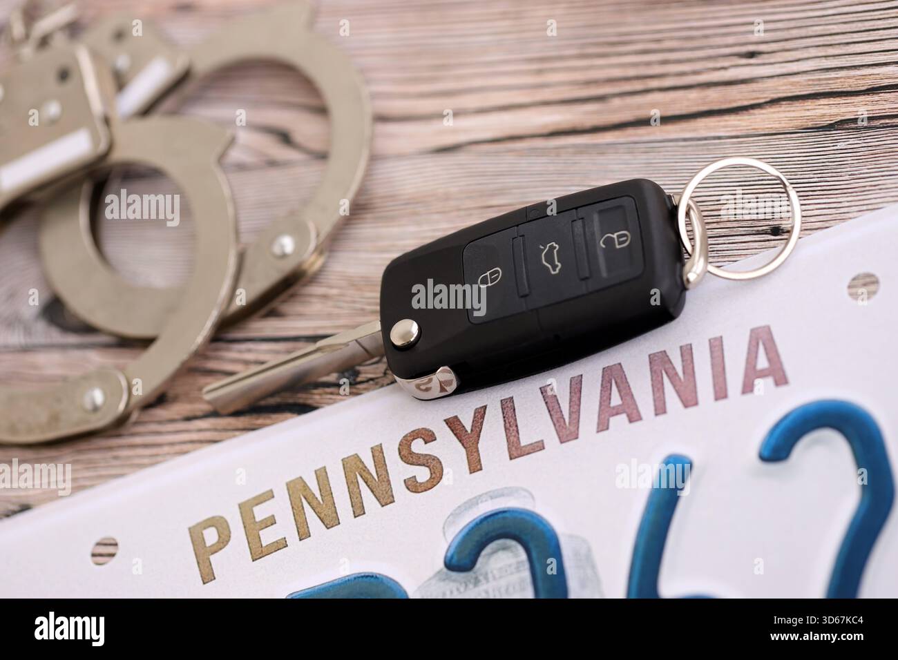 Remote control car keys on Pennsylvania license plate and handcuffs ...