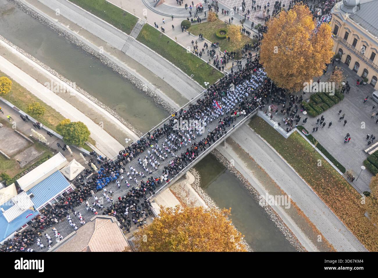 Vukovar, Croatia - 18 November 2025: Aerial view of a somber procession ...