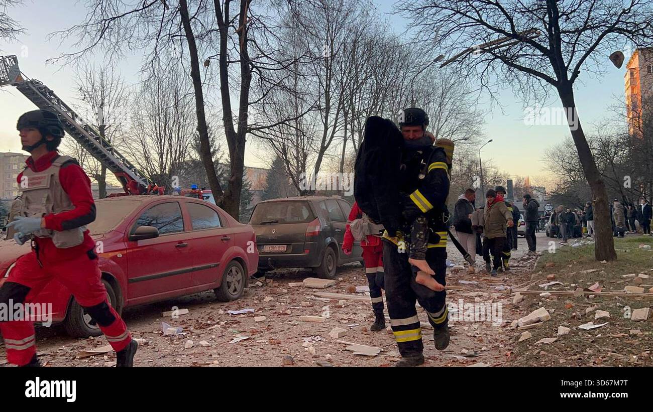 In this photo provided by the Ukrainian Emergency Service, a rescuer ...