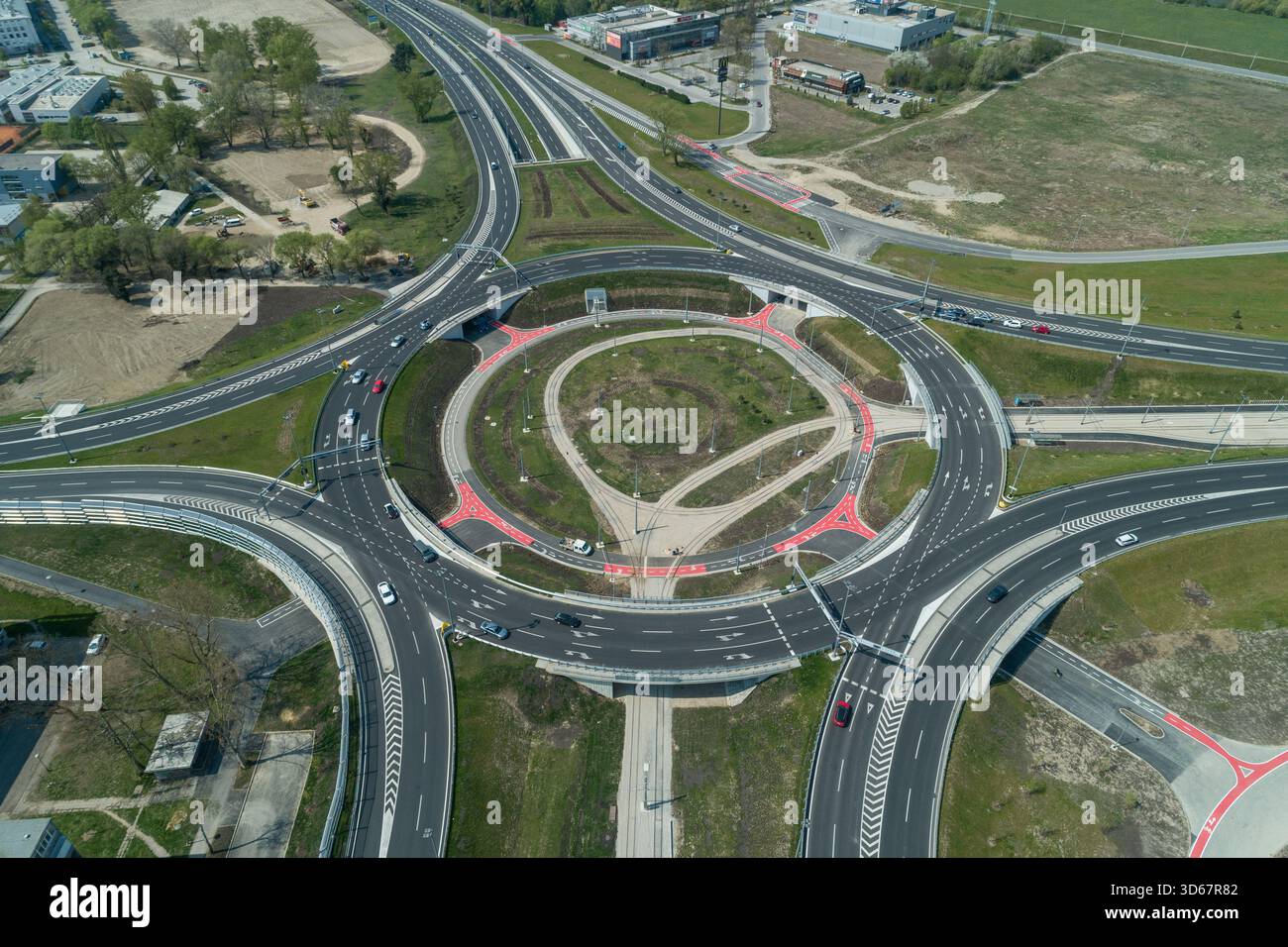 Aerial view of a complex roundabout, arteries of asphalt converging in ...