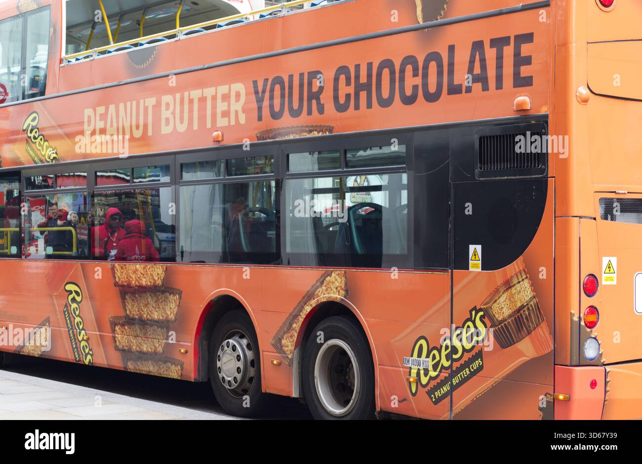 A bus in London with its side covered by an advert for Reese's peanut ...