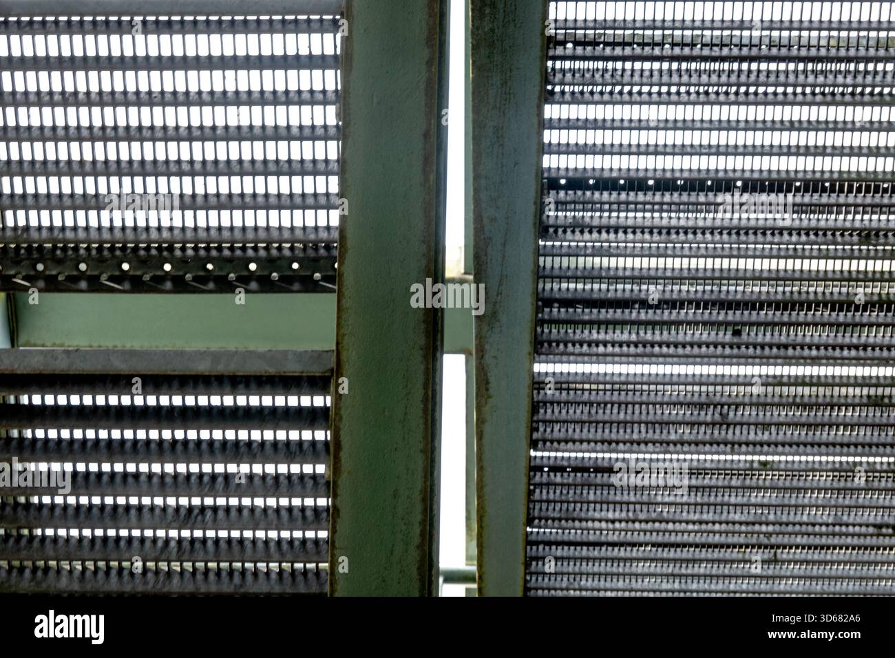 Industrial metal grate stairs viewed from a low angle, creating a ...