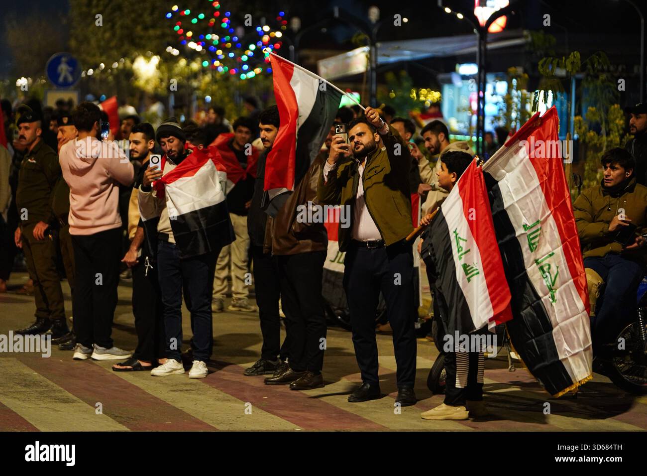Mosul, Iraq. 18th Nov, 2025. Iraqis wave flag as they celebrate ...