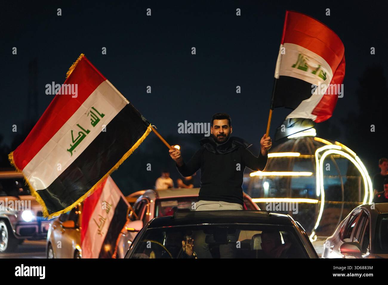 Iraqi young man waves flag as people celebrate following Iraq’s ...