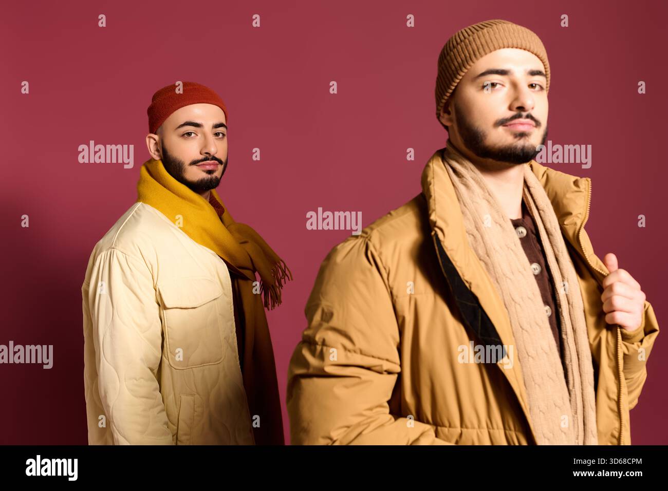 Two brothers dressed in trendy outfits pose confidently, capturing a ...