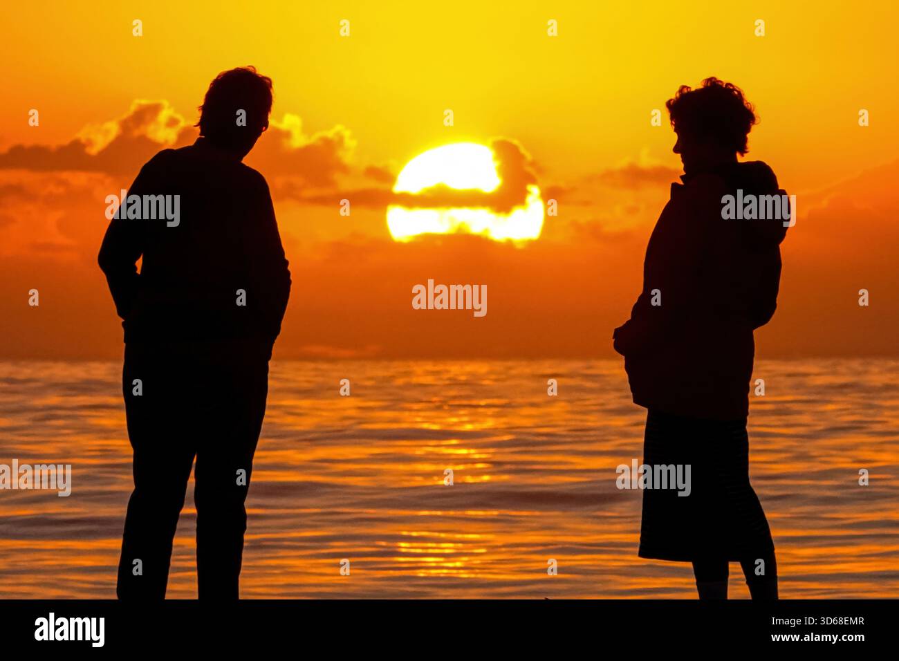 Isle Of Palms, United States. 19 November, 2025. Two women silhouetted ...