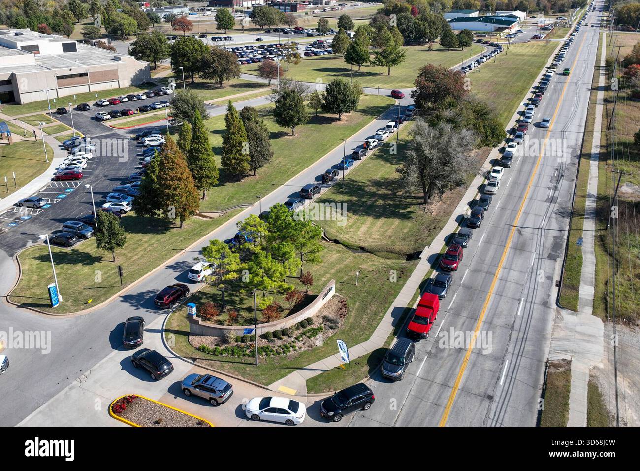FILE - Cars line up for a pop-up food distribution event to provide ...