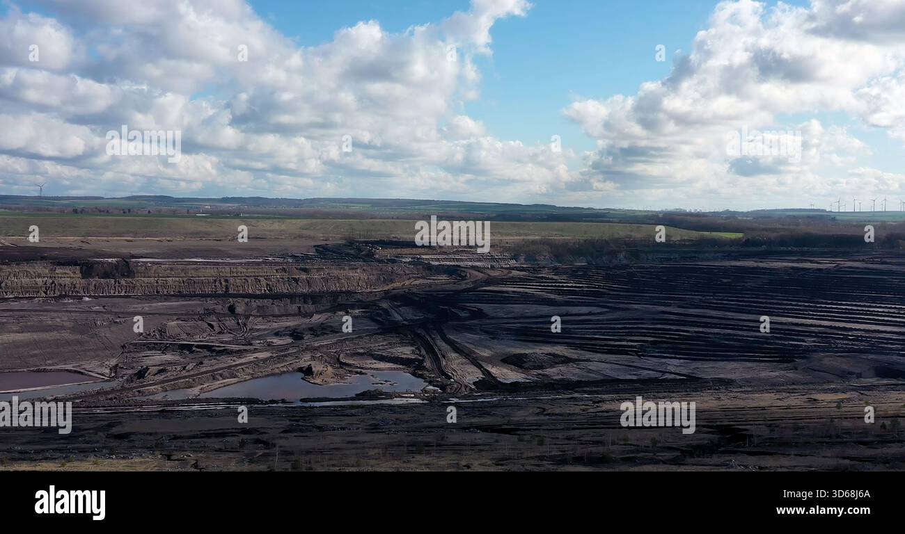 Aerial perspective of a large open-pit lignite mine showing industrial ...