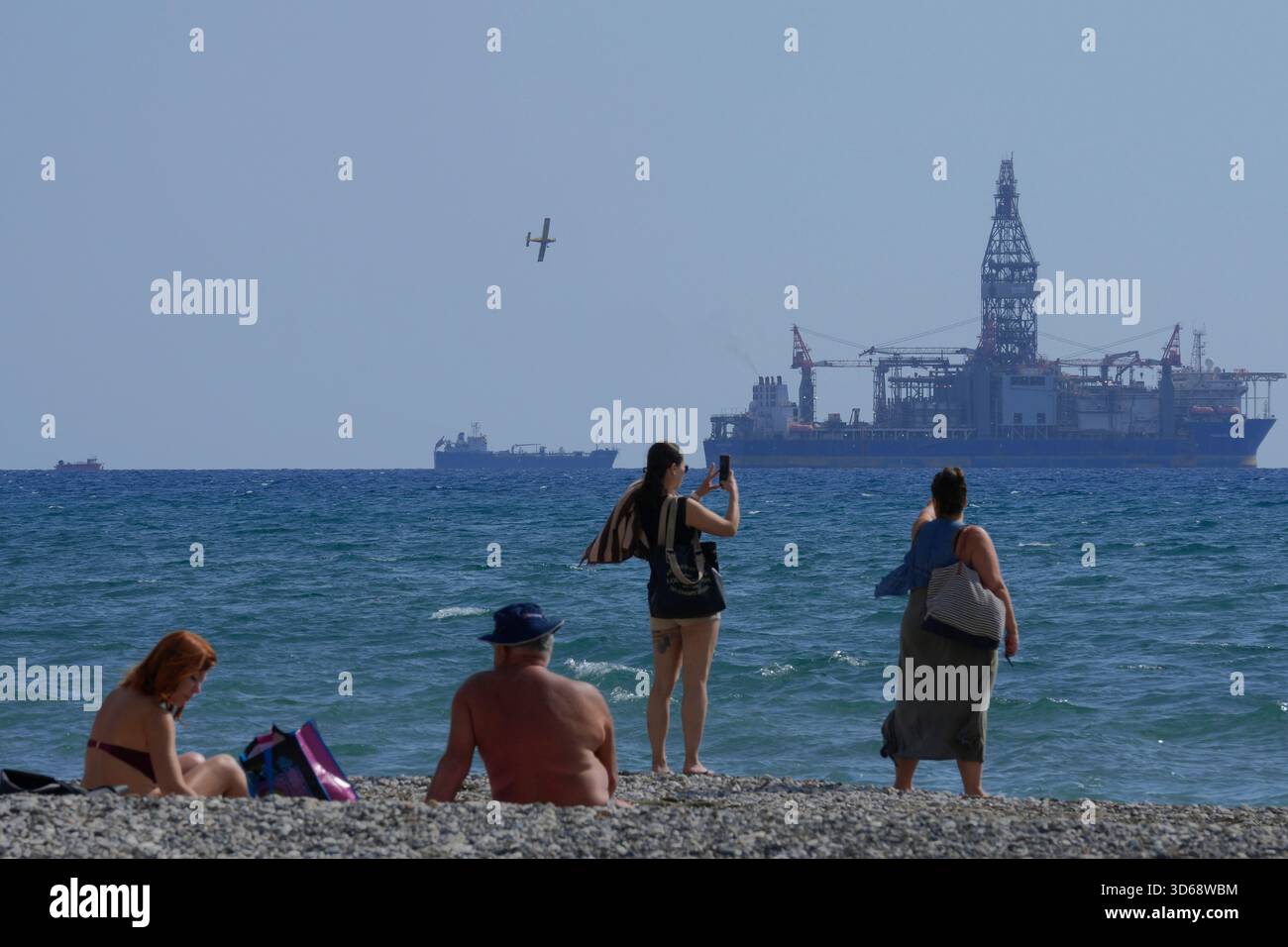 FILE - People on the beach take photos of the 'Tungsten Explorer ...