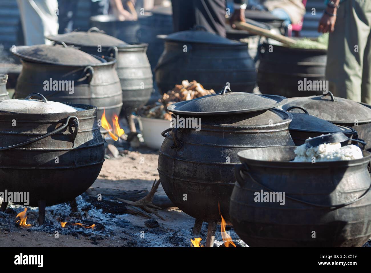 traditional outdoor cooking scene, in Botswana, featuring several large ...