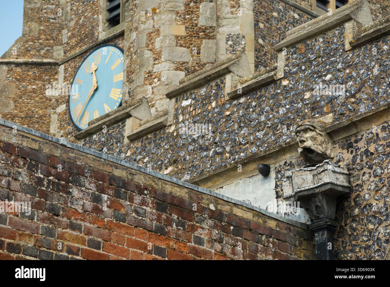 The West Tower clock face and gorgoyle rain water drain outlet and lead ...