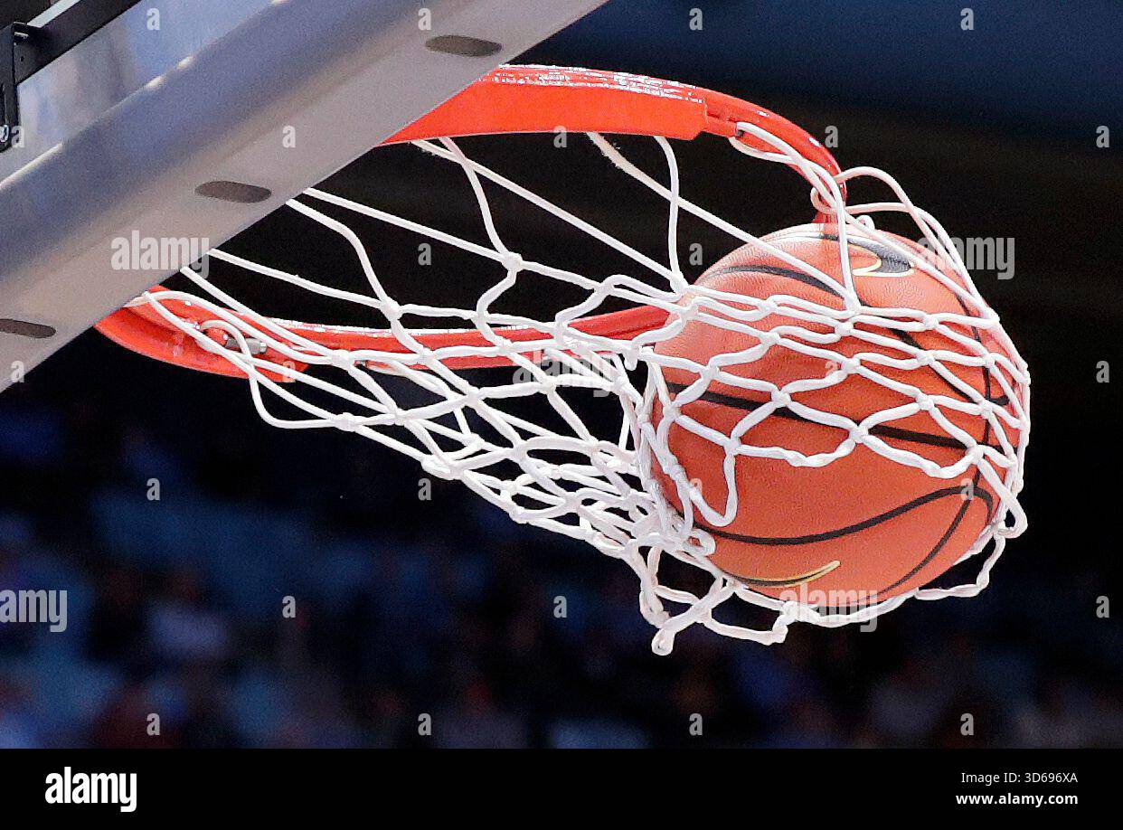 A North Carolina player makes a basket during the first half of an NCAA ...