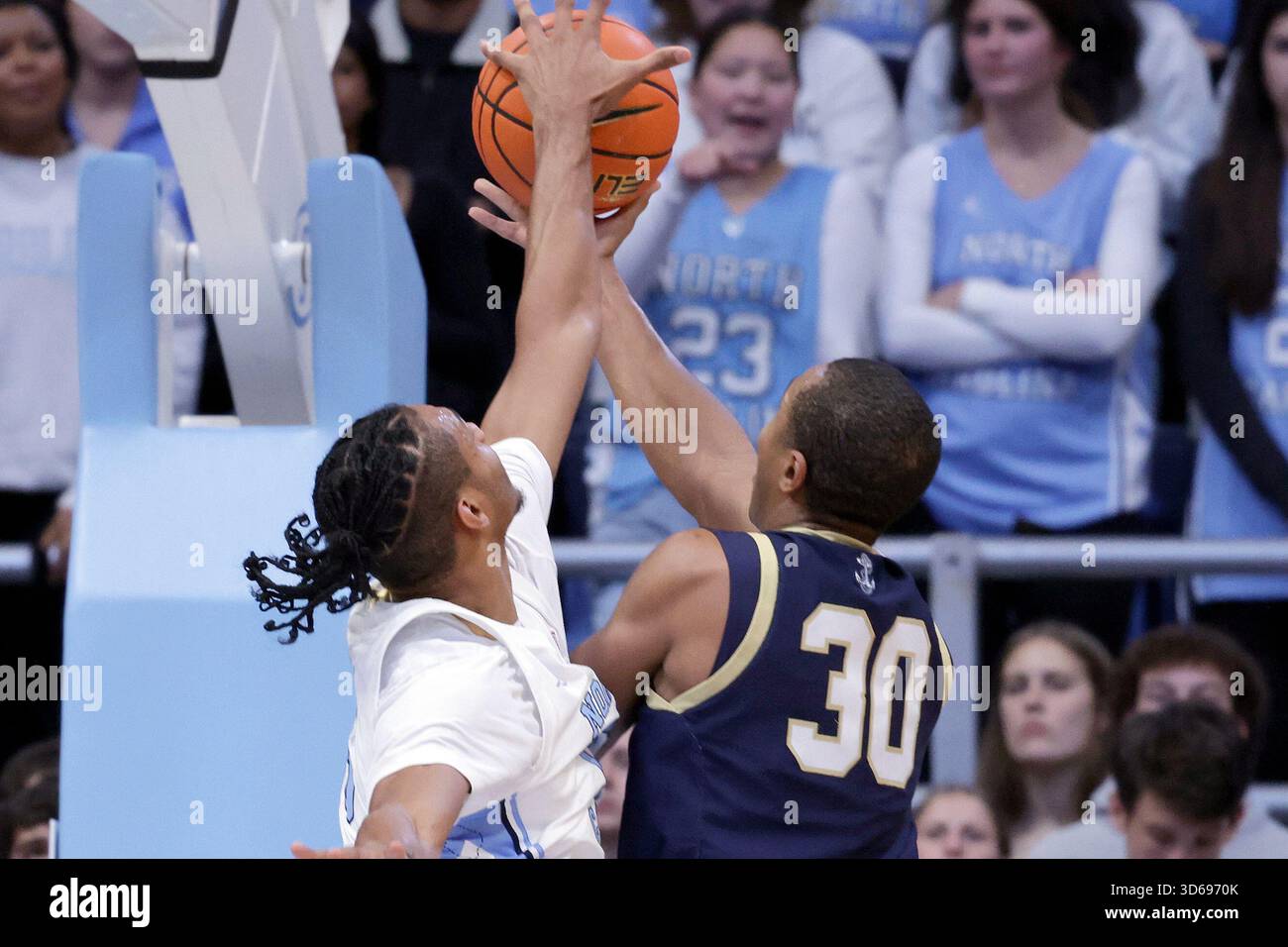 North Carolina forward Jarin Stevenson, left, blocks a shot by Navy ...
