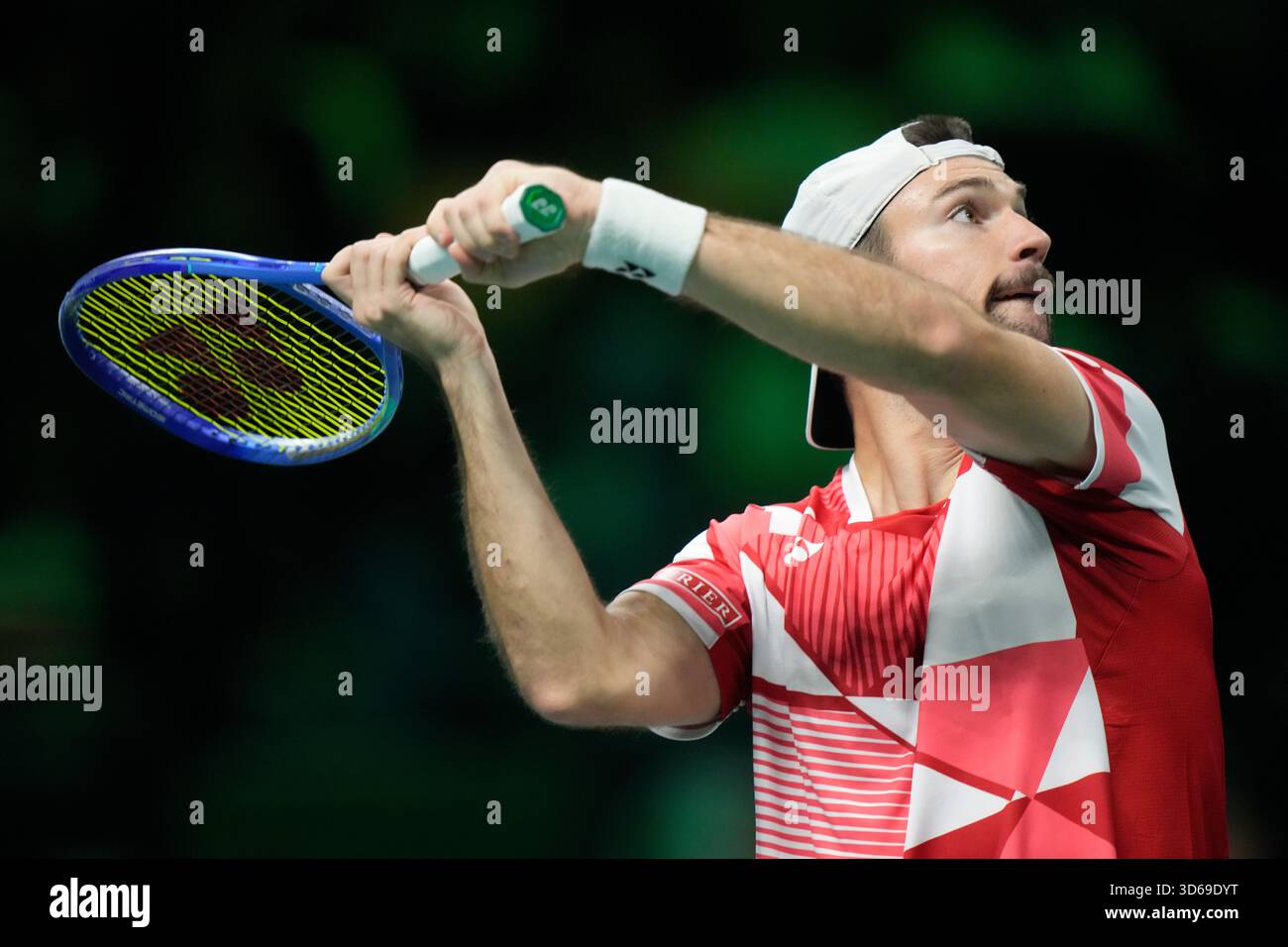 Austria's Jurij Rodionov returns the ball to Italy's Matteo Berrettini ...