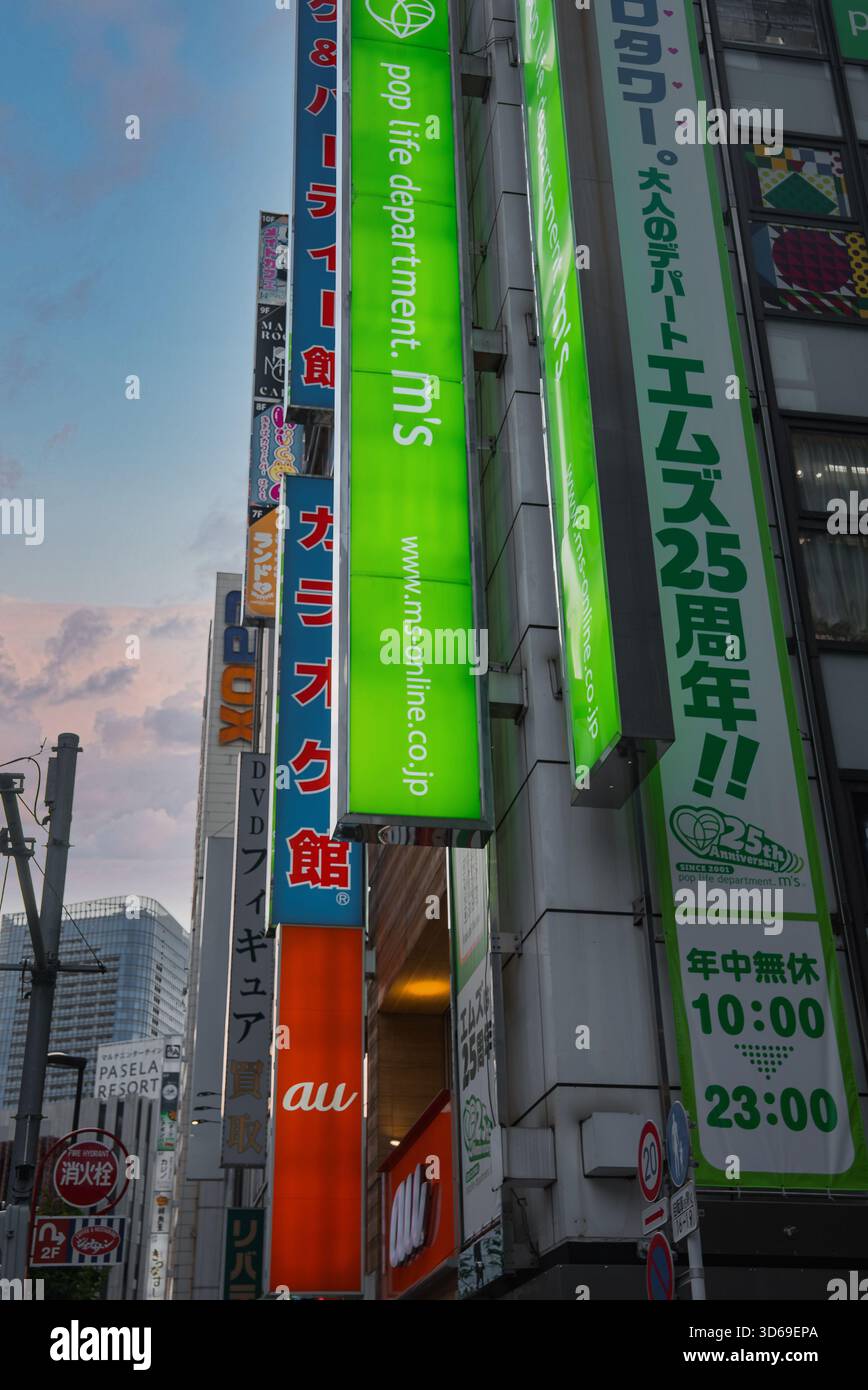 Neon signboards and shop banners in Akihabara, Tokyo at dusk Stock ...