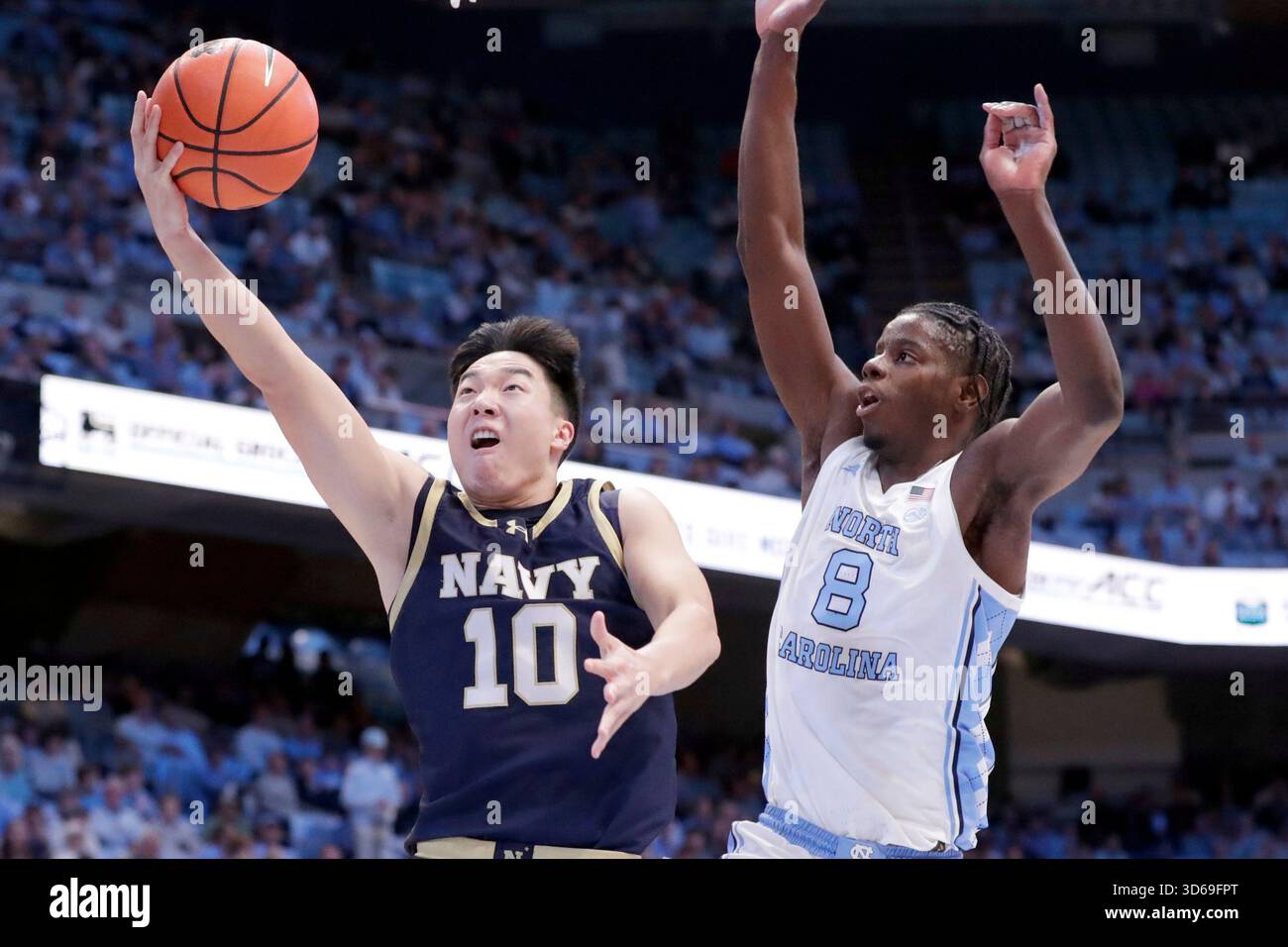 Navy guard Jinwoo Kim (10) drives against North Carolina forward Caleb ...