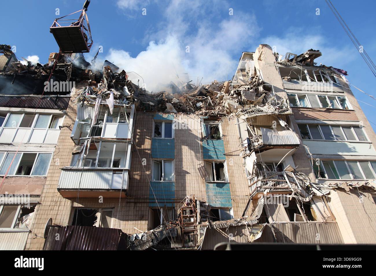 Rescue workers clear the rubble of a residential building which was ...