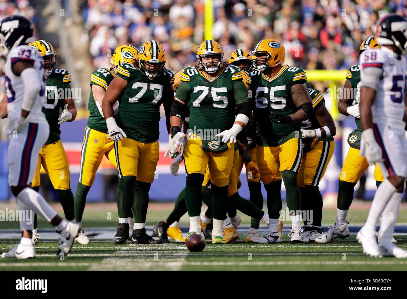 Green Bay Packers guard Sean Rhyan (75) with teammates at the line of ...