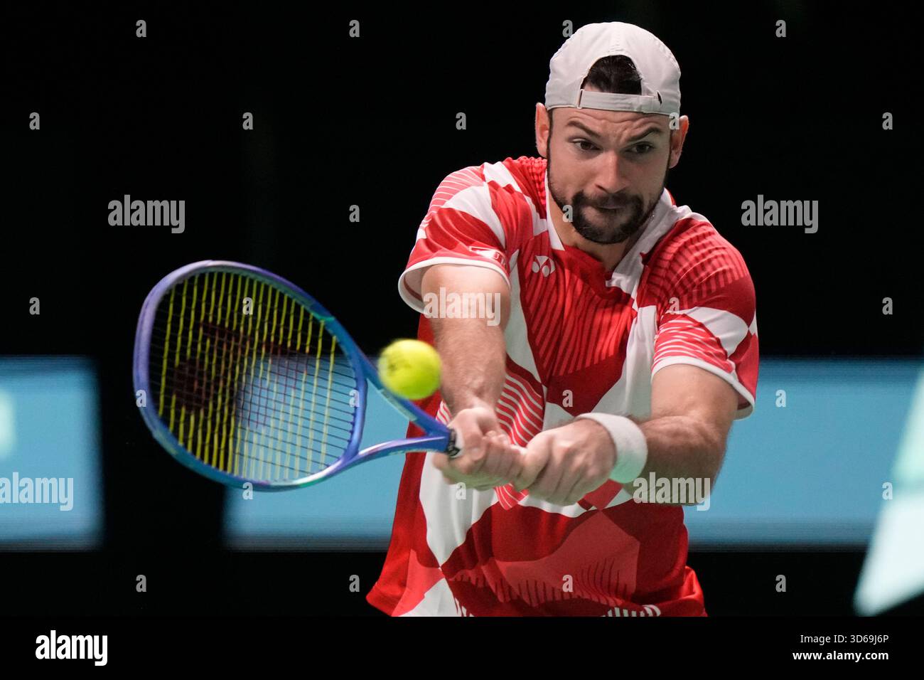 Austria's Jurij Rodionov returns the ball to Italy's Matteo Berrettini ...