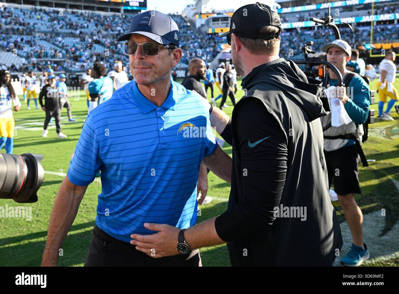 Los Angeles Chargers head coach Jim Harbaugh, left, and Jacksonville ...