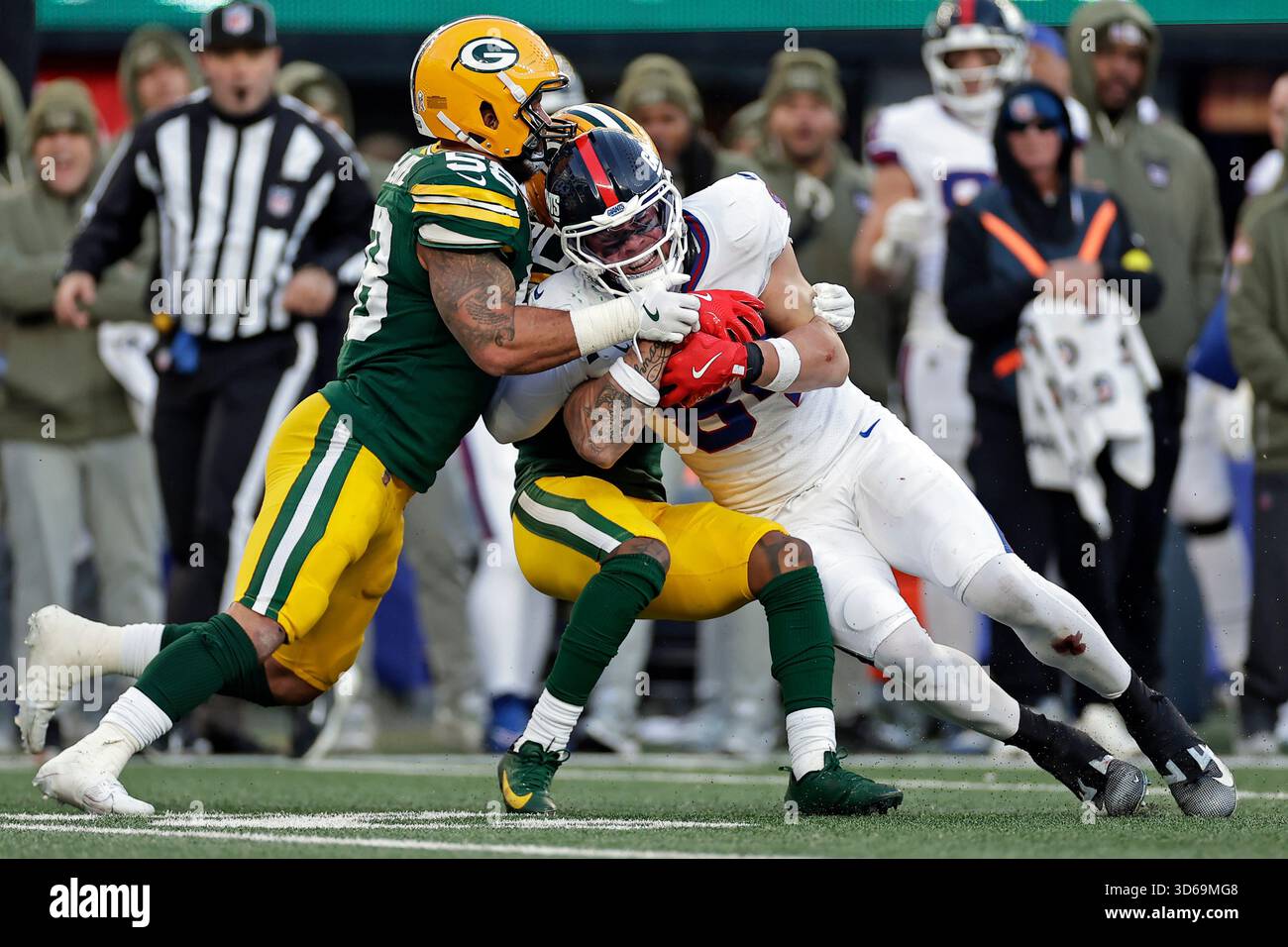 New York Giants tight end Theo Johnson (84) is tackled by Green Bay ...