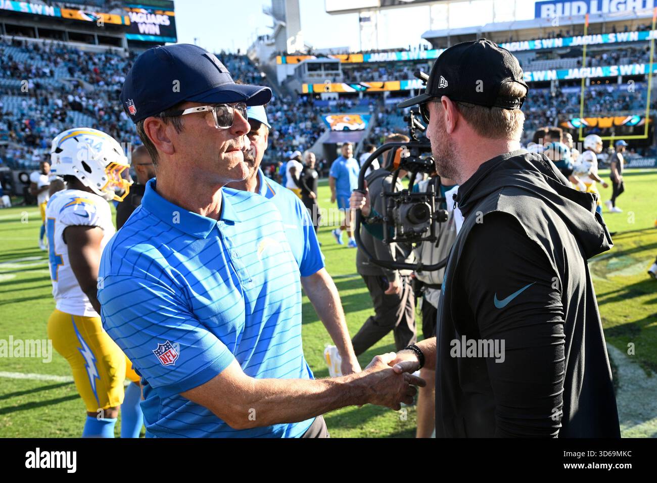 Los Angeles Chargers head coach Jim Harbaugh, left, and Jacksonville ...