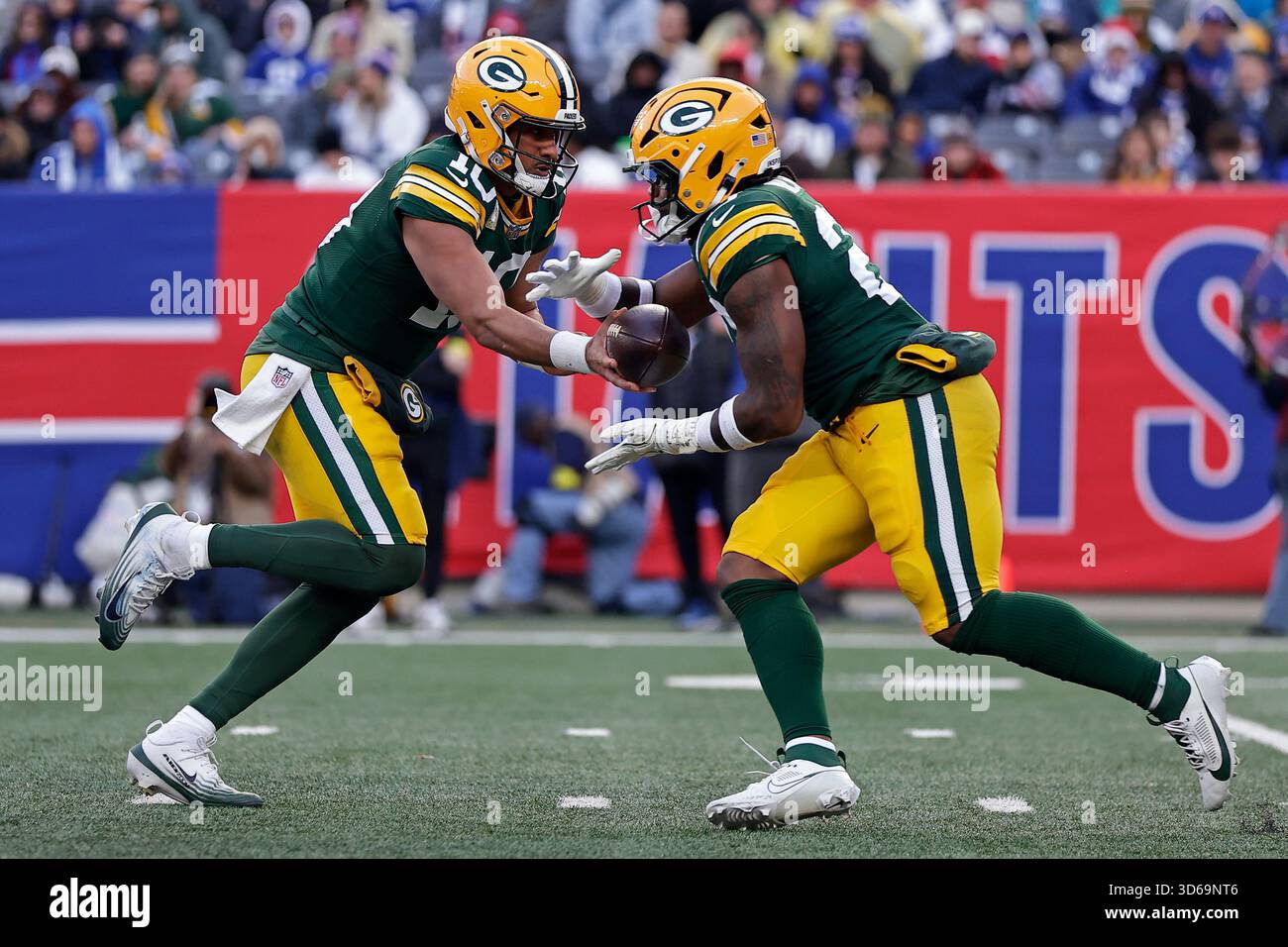 Green Bay Packers quarterback Jordan Love (10) hands the ball off to ...
